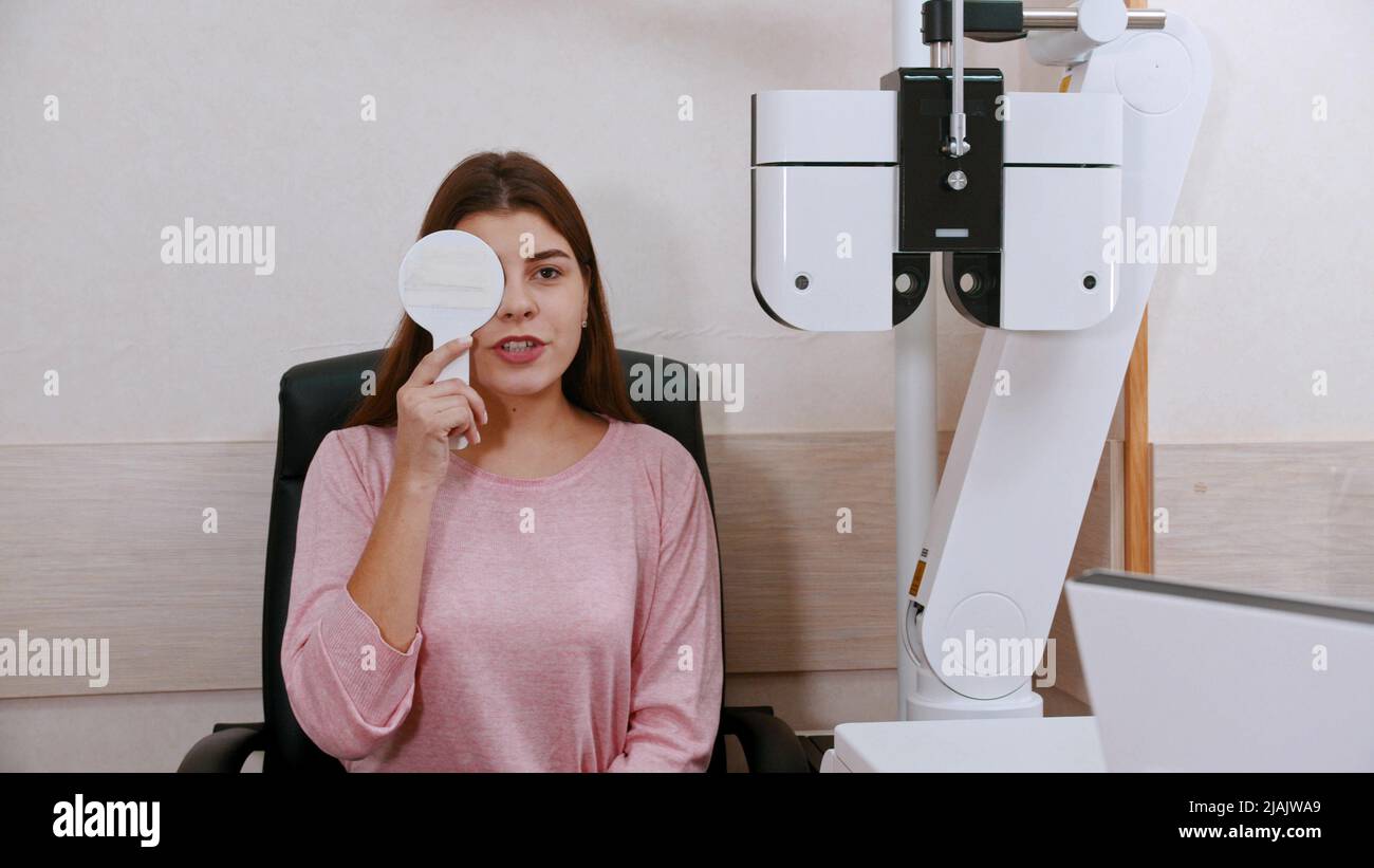 Ophthalmology treatment - young woman checking her visual acuity Stock ...