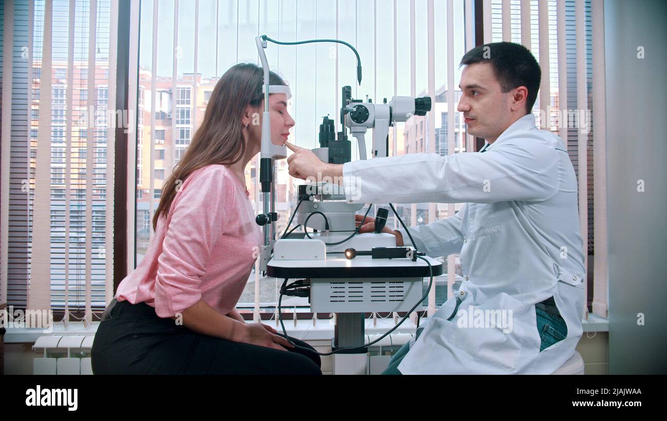 Ophthalmology treatment - young pretty smiling woman checking her ...