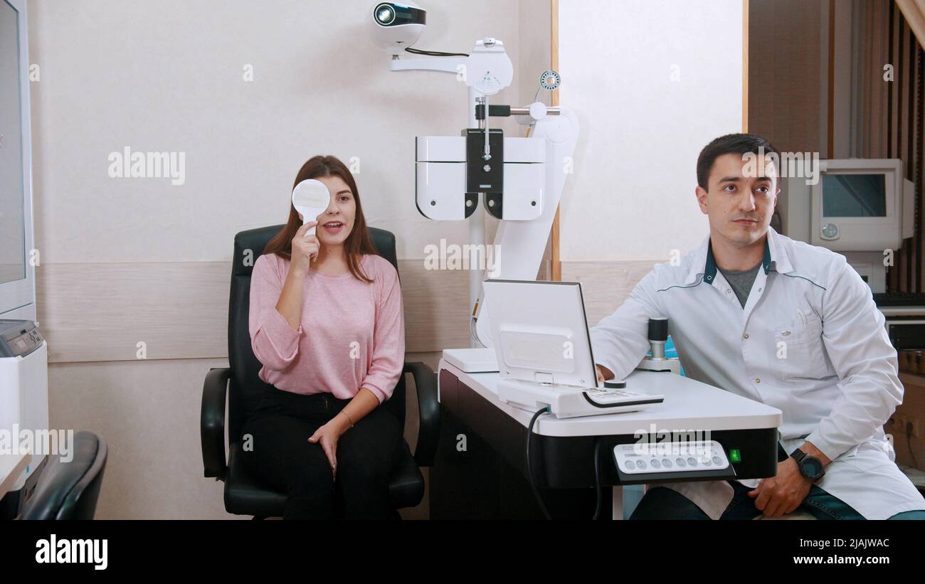 Ophthalmology treatment - young woman checking her visual acuity ...