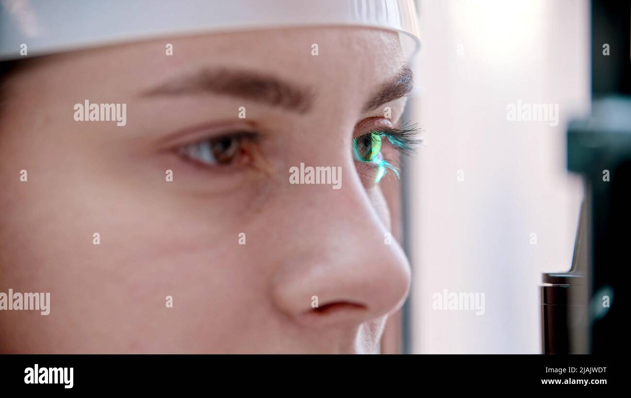 Ophthalmology - a young woman checking her visual acuity - checking a ...