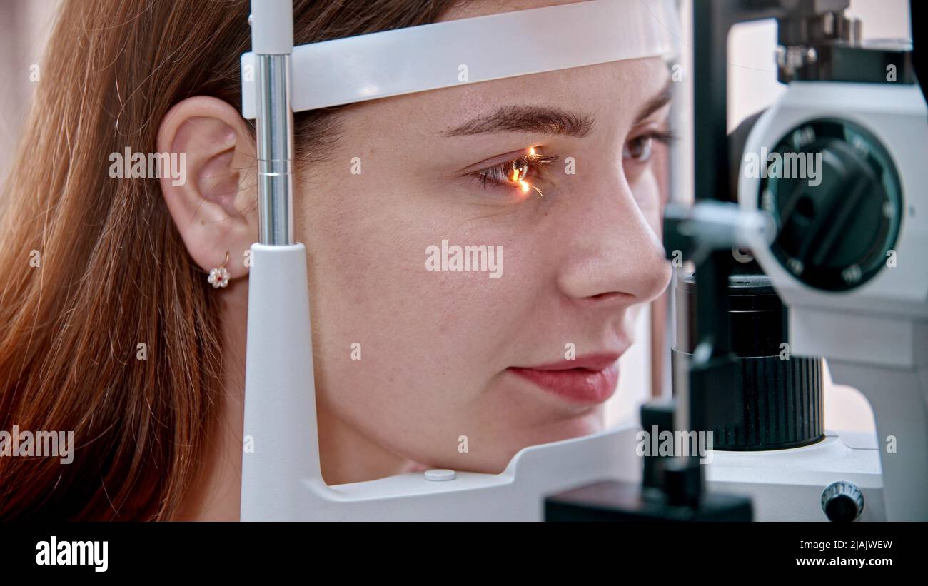 Ophthalmology treatment - a young pretty woman checking her visual ...