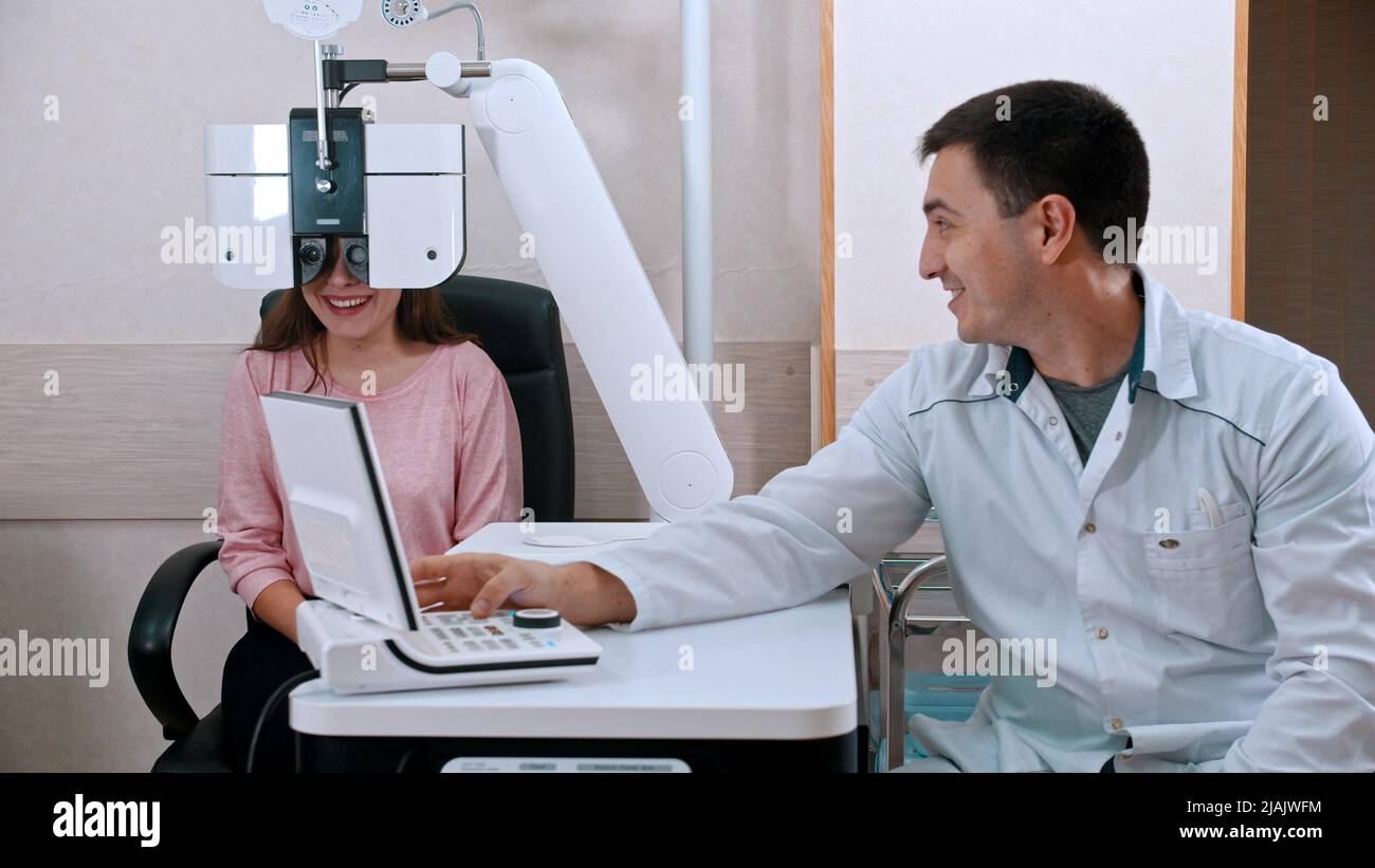 Ophthalmology treatment - young smiling woman checking her visual ...