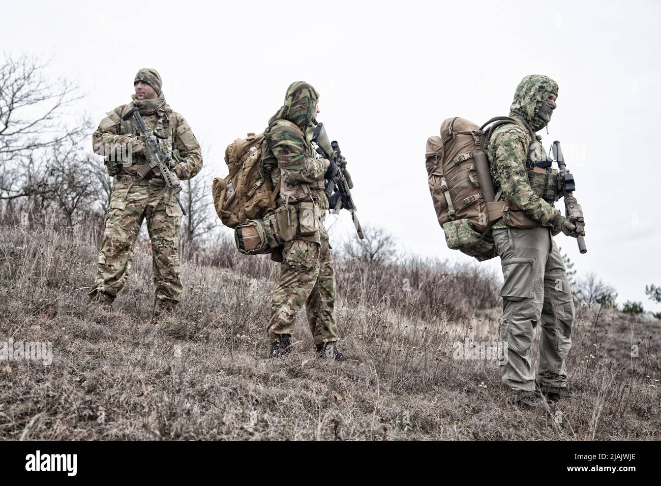 Army soldiers on a patrol mission, observing territory from a hill ...
