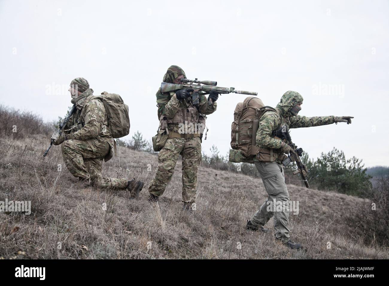 Army soldiers on a patrol mission, observing territory from a hill ...