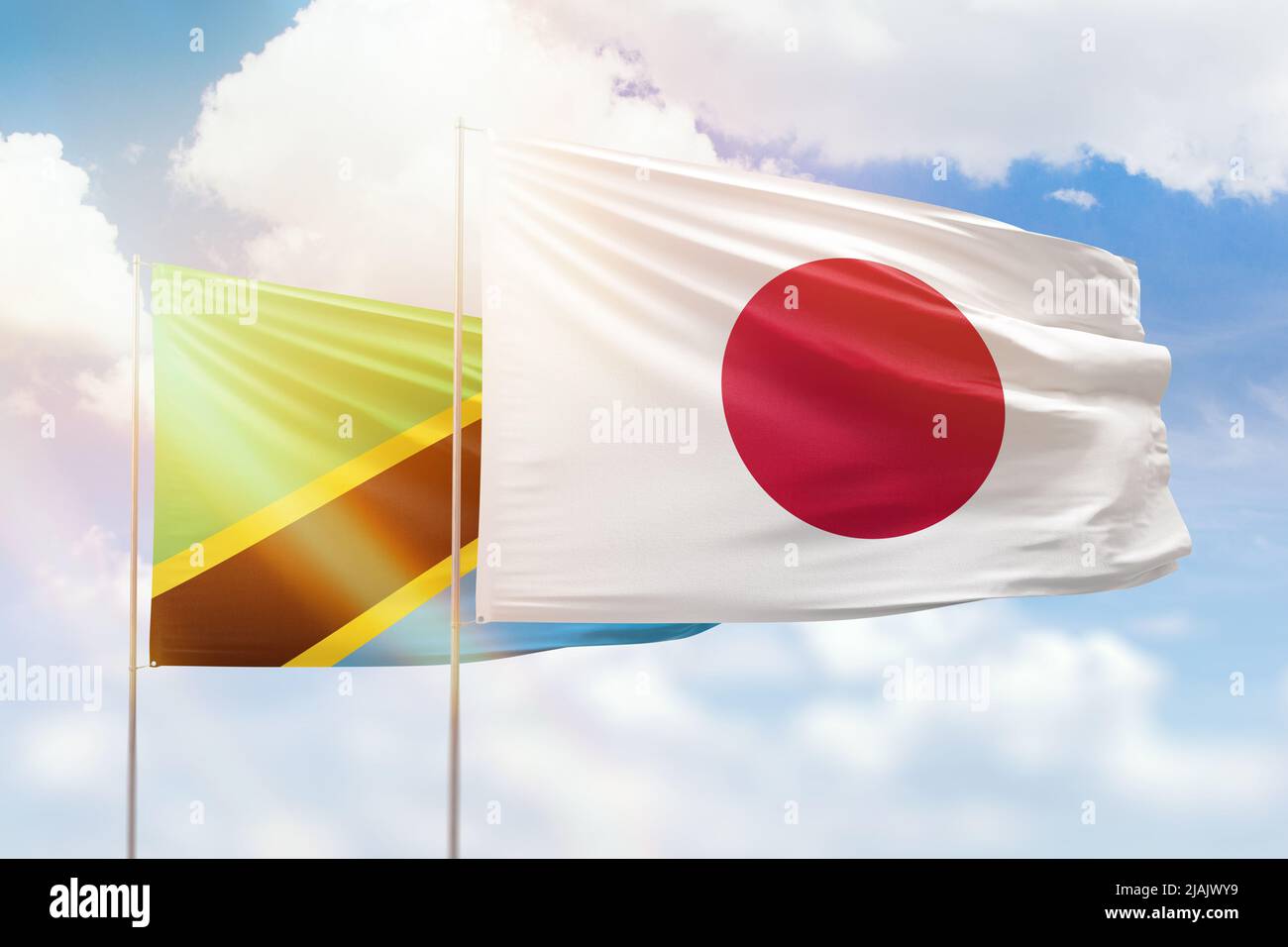 Sunny blue sky and flags of japan and tanzania Stock Photo - Alamy