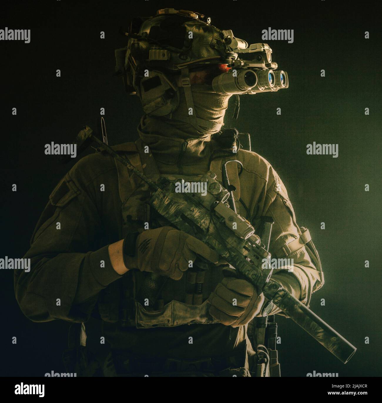 Special forces fighter armed with submachine gun, looking through night ...