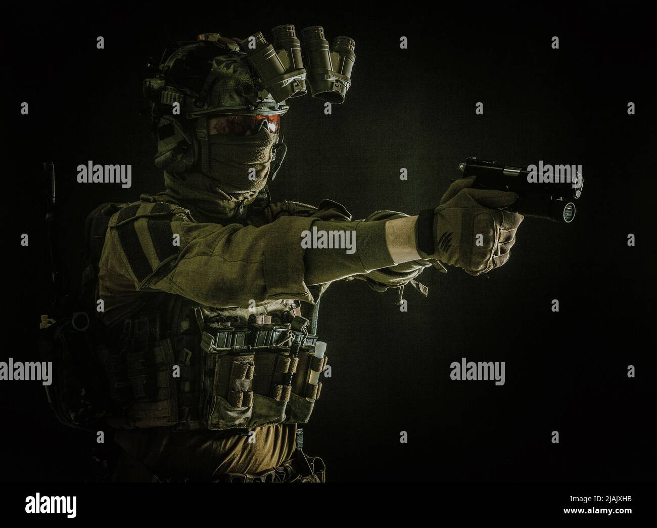 Modern soldier in combat uniform, helmet and radio headset, shooting ...