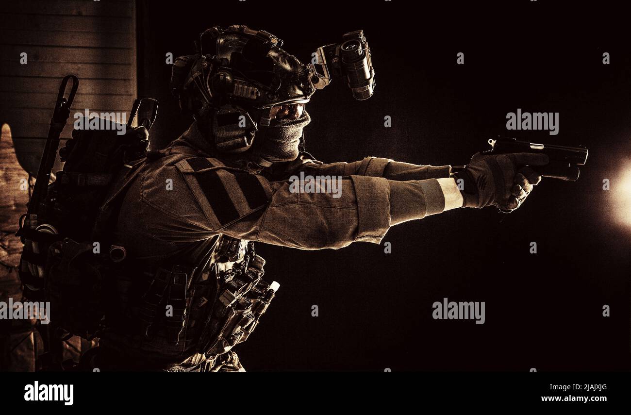 Modern soldier in combat uniform, helmet and radio headset, shooting ...