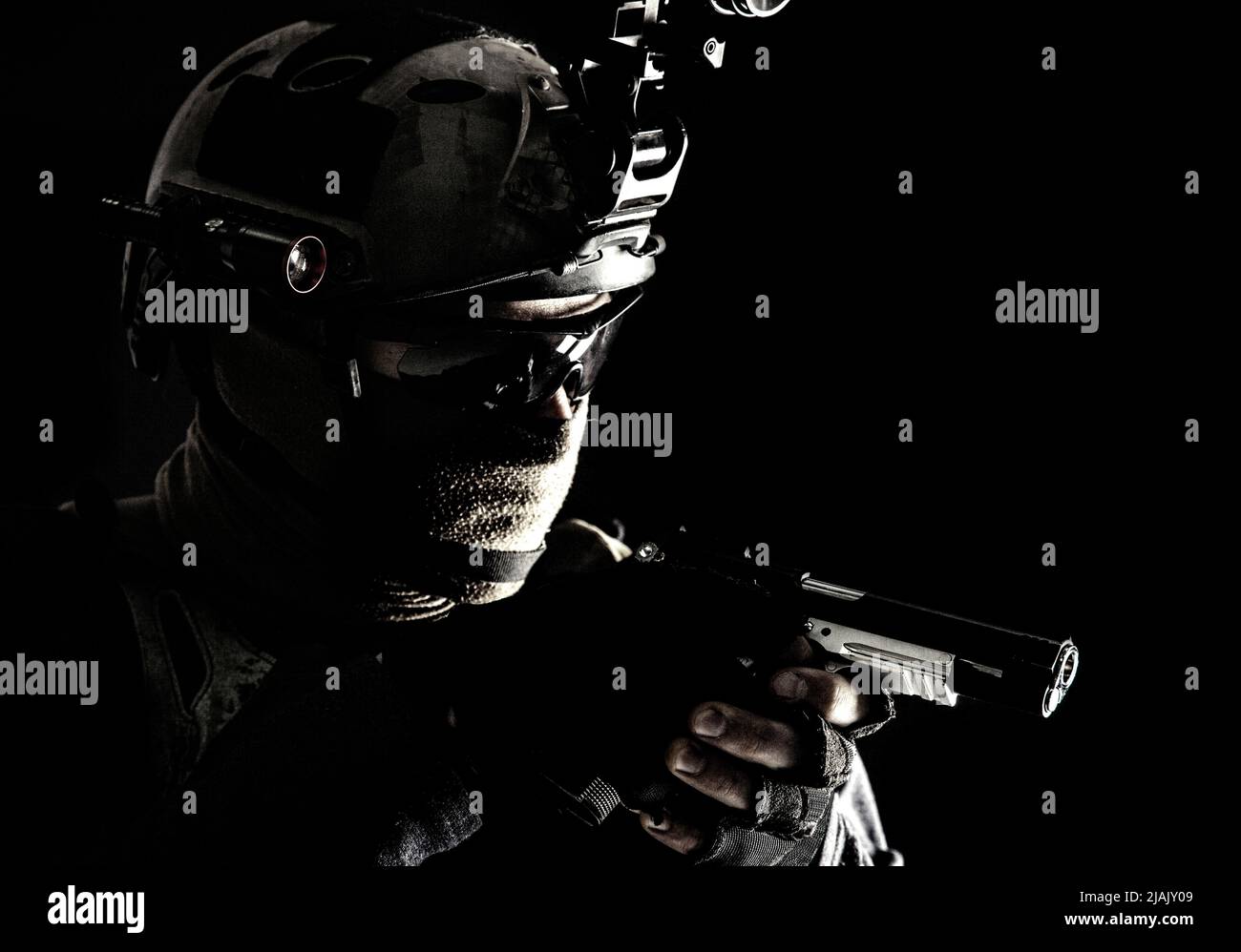 Police SWAT team fighter aiming pistol while sneaking in the darkness ...