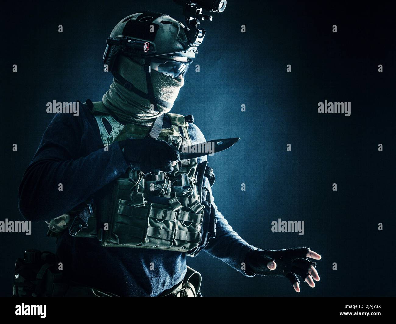 Commando fighter wearing a helmet with night vision, sneaking in the ...