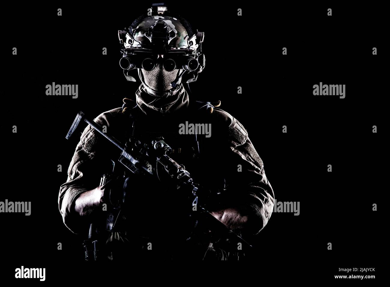 Special operations soldier equipped with night vision device, radio ...