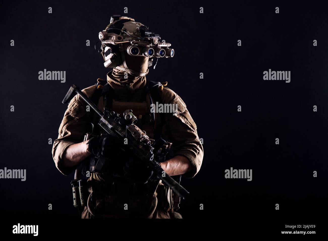Special operations fighter looking aside, equipped night vision device ...