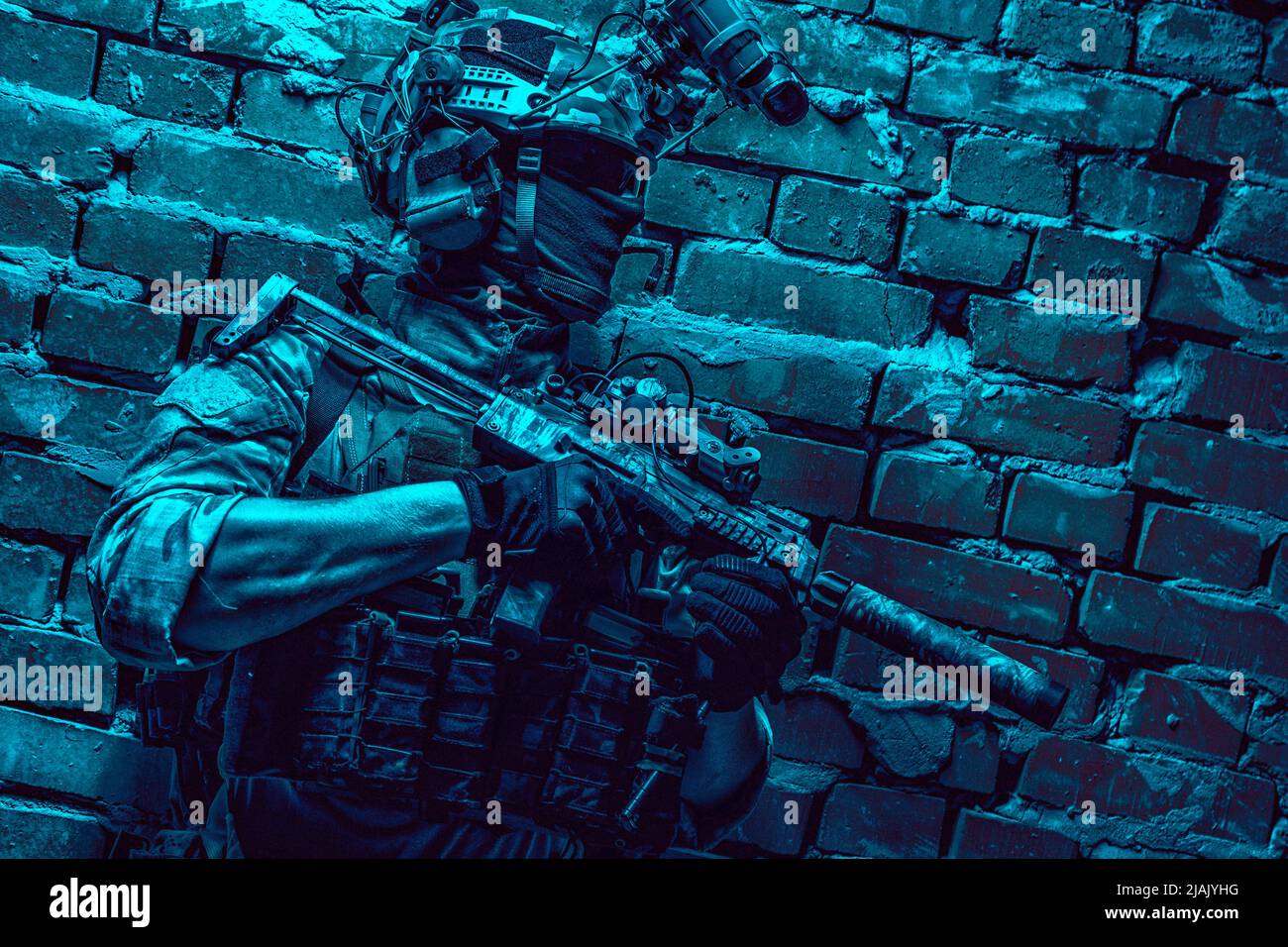 An elite soldier holding a shotgun against a brick wall, wearing face ...