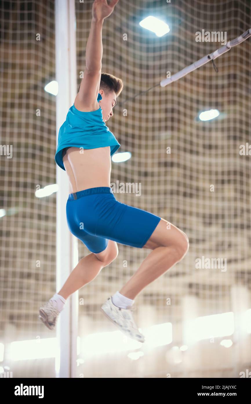 Pole vaulting indoors - young fit man falling down after jumping Stock ...