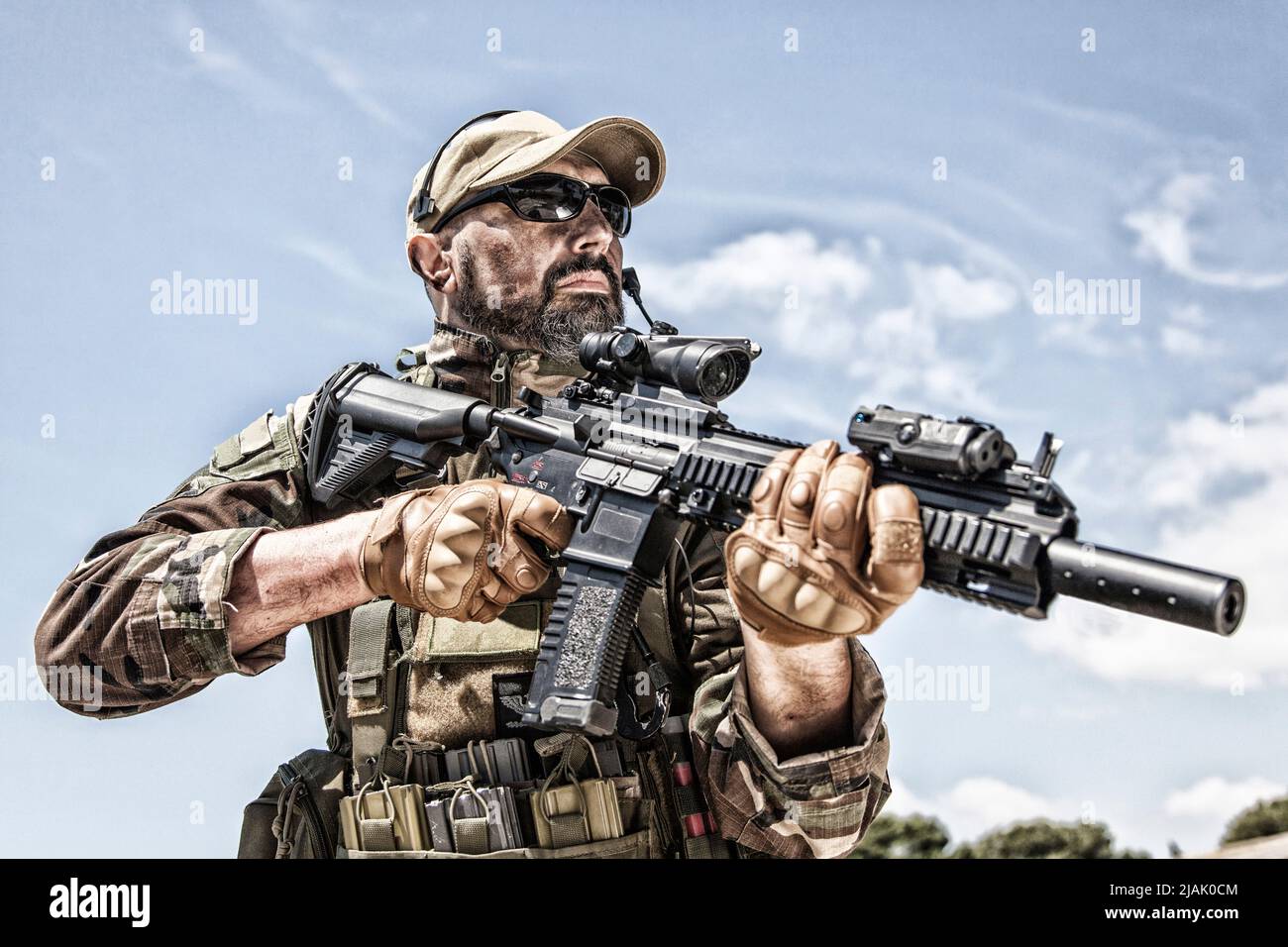 Private military company mercenary in battle uniform, holding service ...