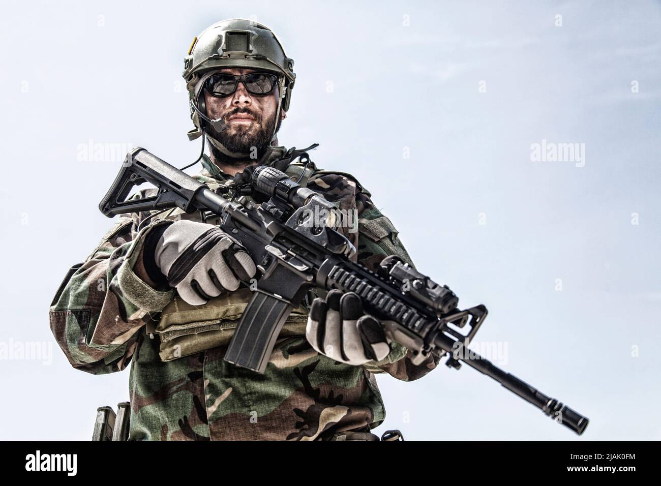 Private military company mercenary in battle uniform, holding service ...