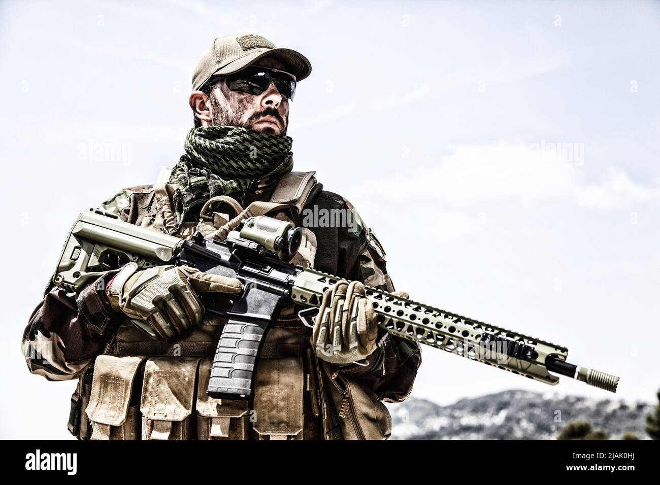 Private military company mercenary in battle uniform, holding service ...