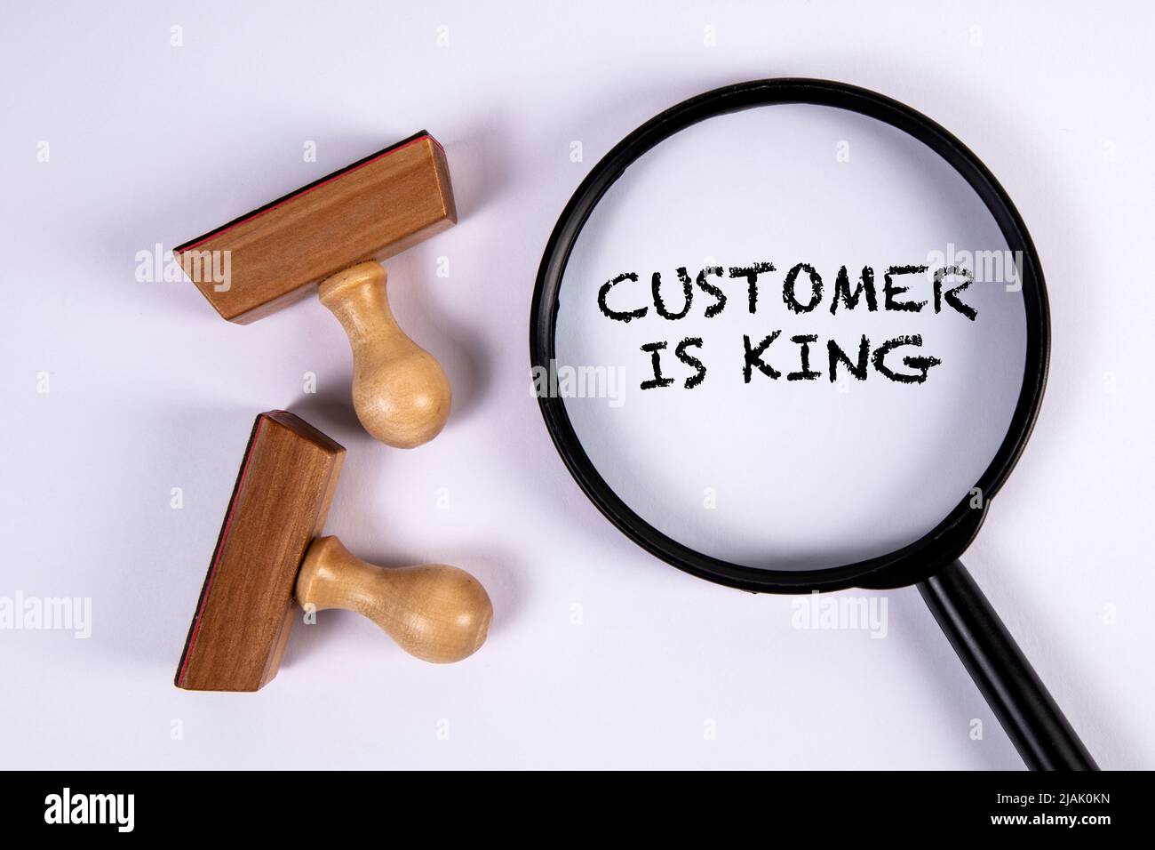Customer is king. Magnifying glass and stamps on white background Stock ...