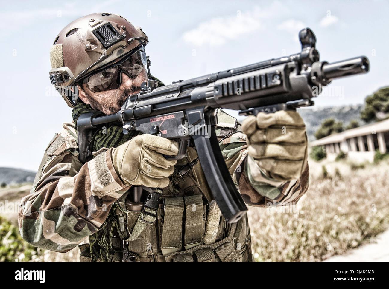 Close-up of a commando fighter shooting a submachine gun Stock Photo ...