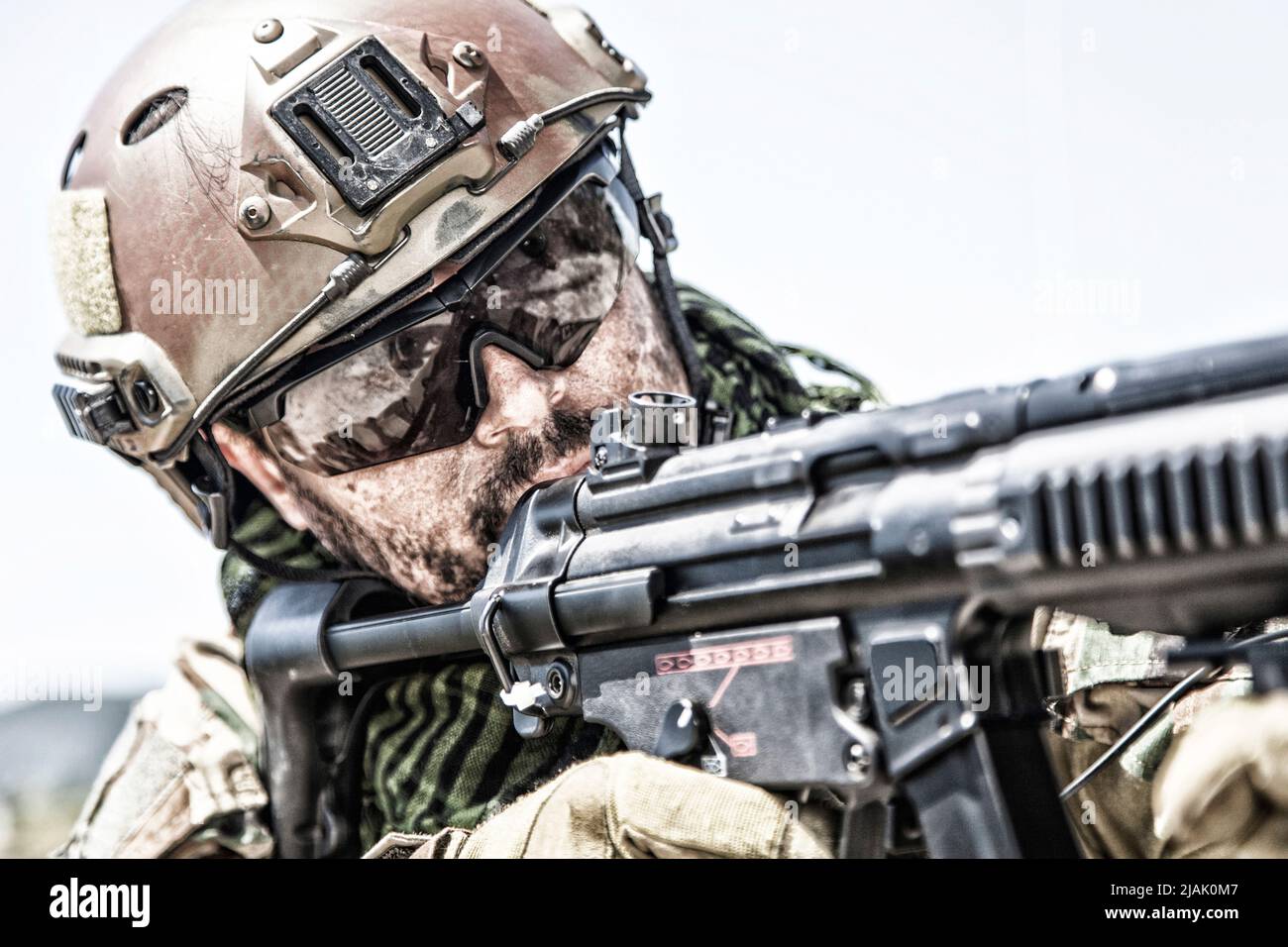 Close-up of a commando fighter shooting a submachine gun Stock Photo ...
