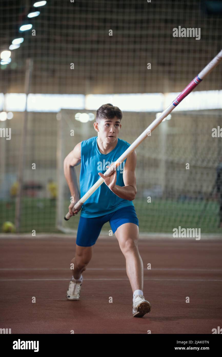 Pole vault training in the sports stadium - young man running on the ...