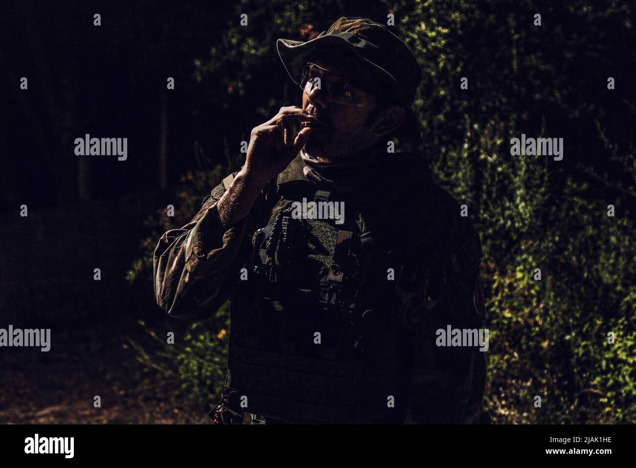 Army soldier smoking cigarette at night Stock Photo - Alamy