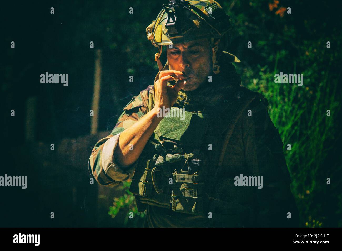 Army soldier smoking cigarette at night Stock Photo - Alamy