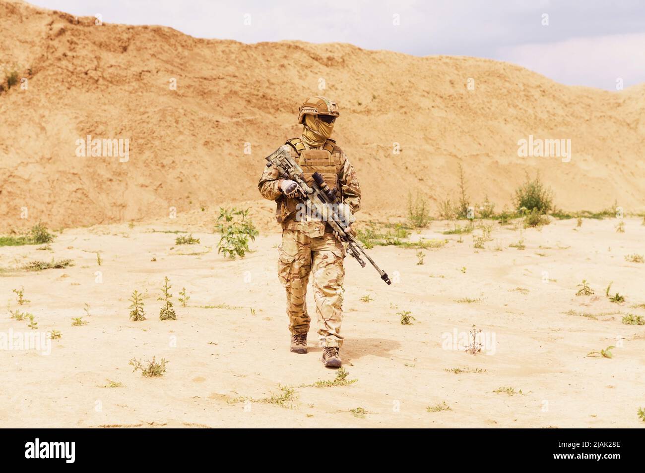 Equipped special forces soldier walking across desert Stock Photo - Alamy