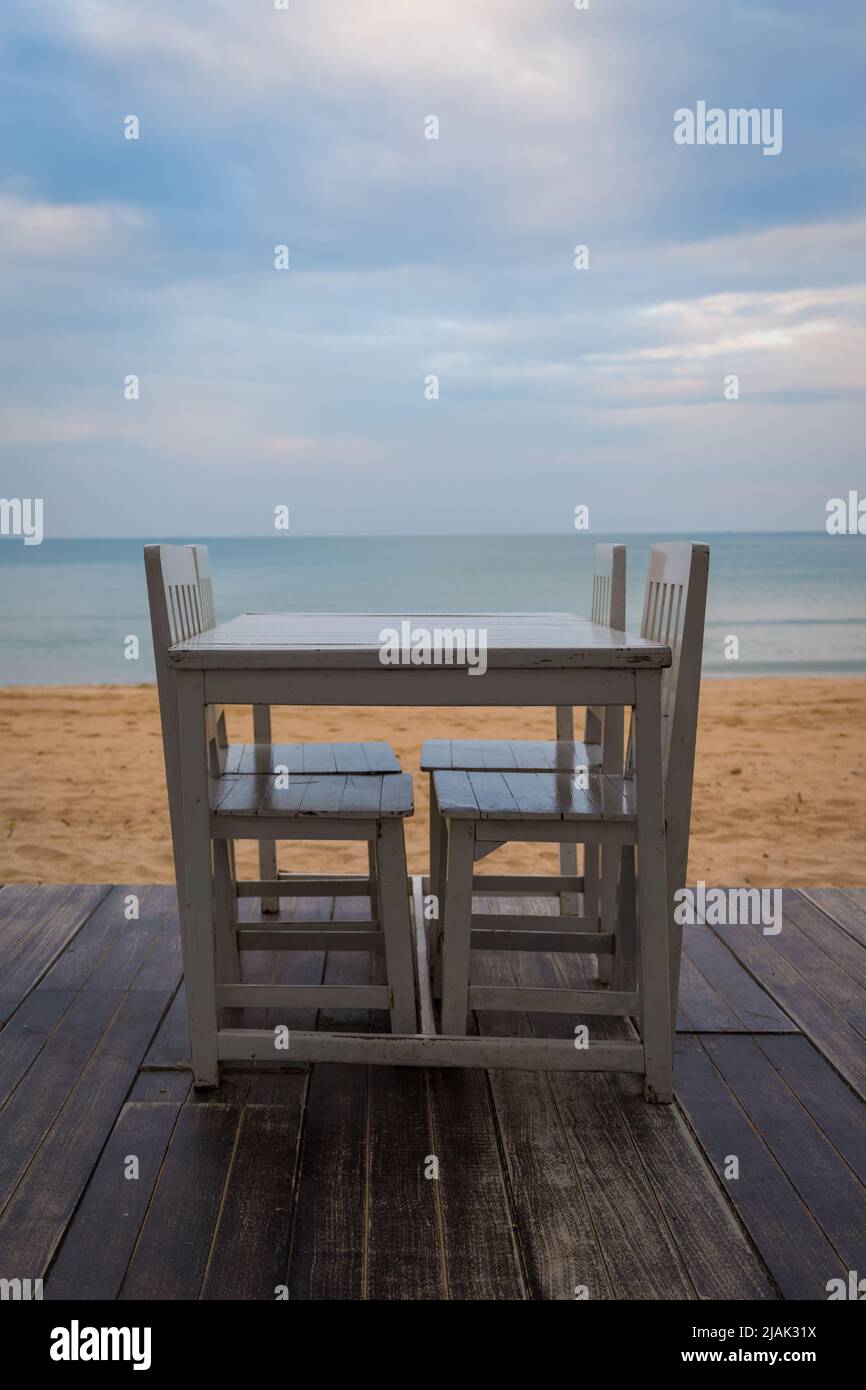 White table for dinner on the beach and sky background Stock Photo - Alamy