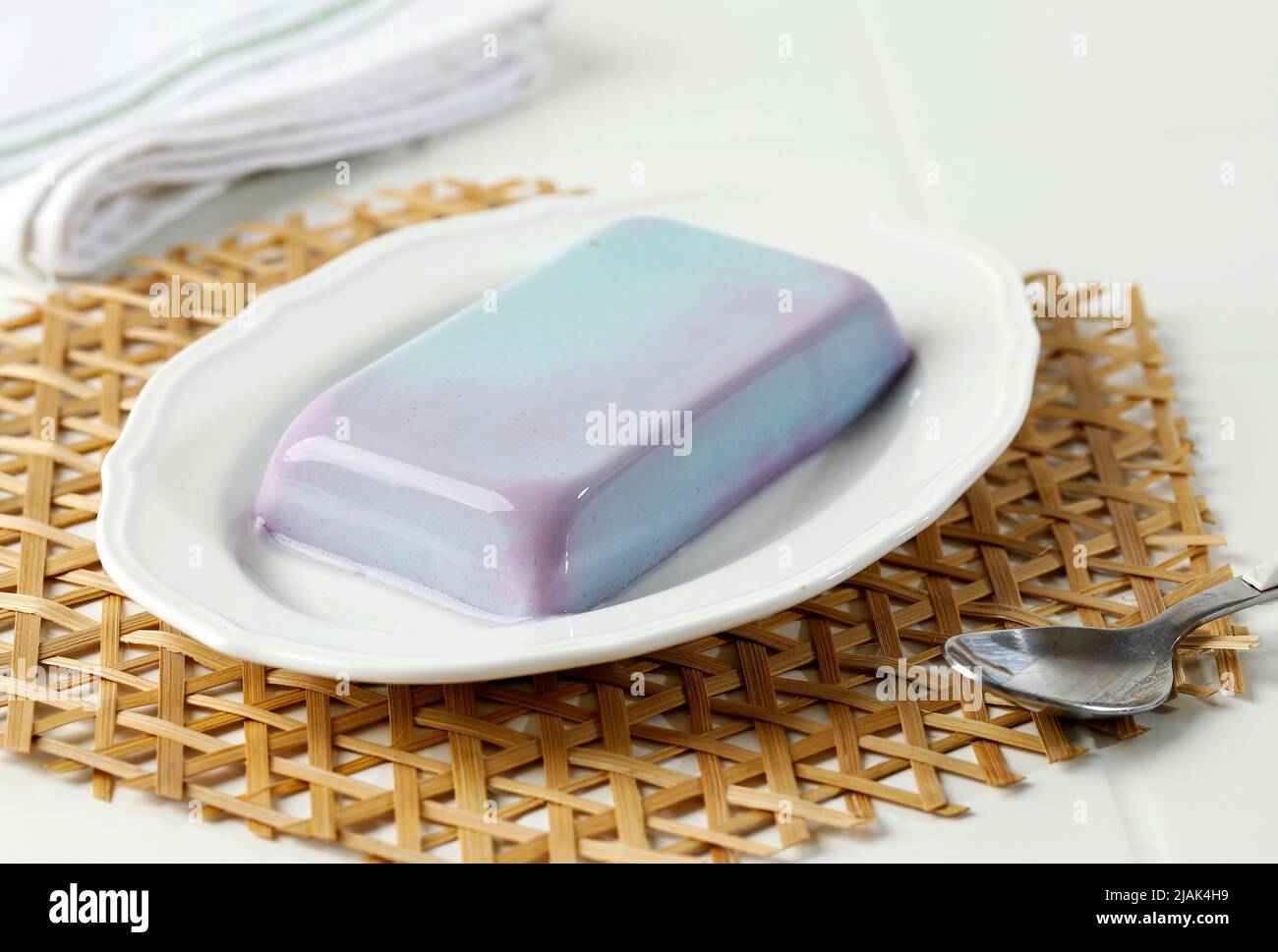 Bubblegum Pudding on White Plate. HOmemade Soft Silky Pudding with Blue ...