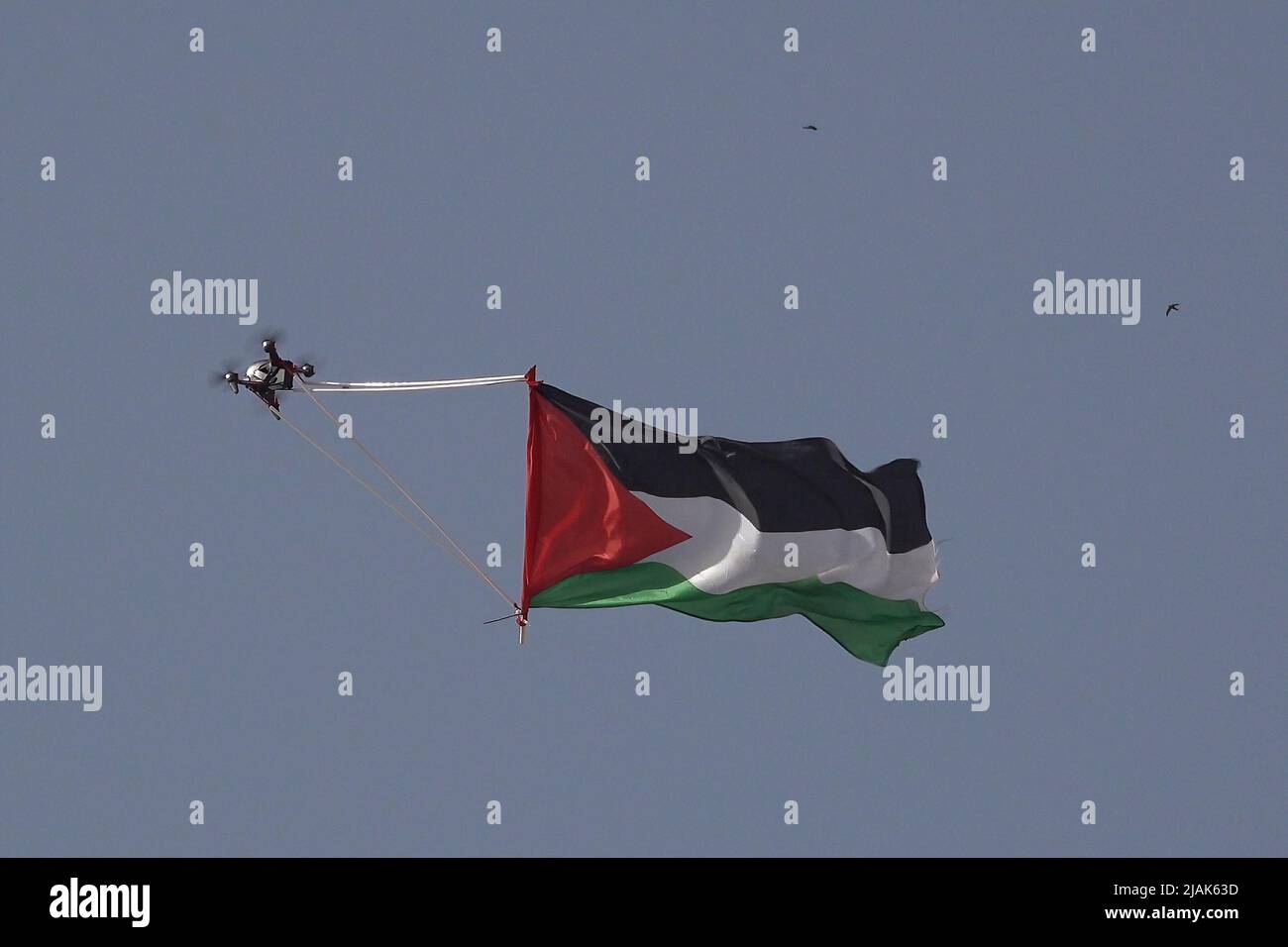 A drone, carrying the Palestinian flag Stock Photo - Alamy