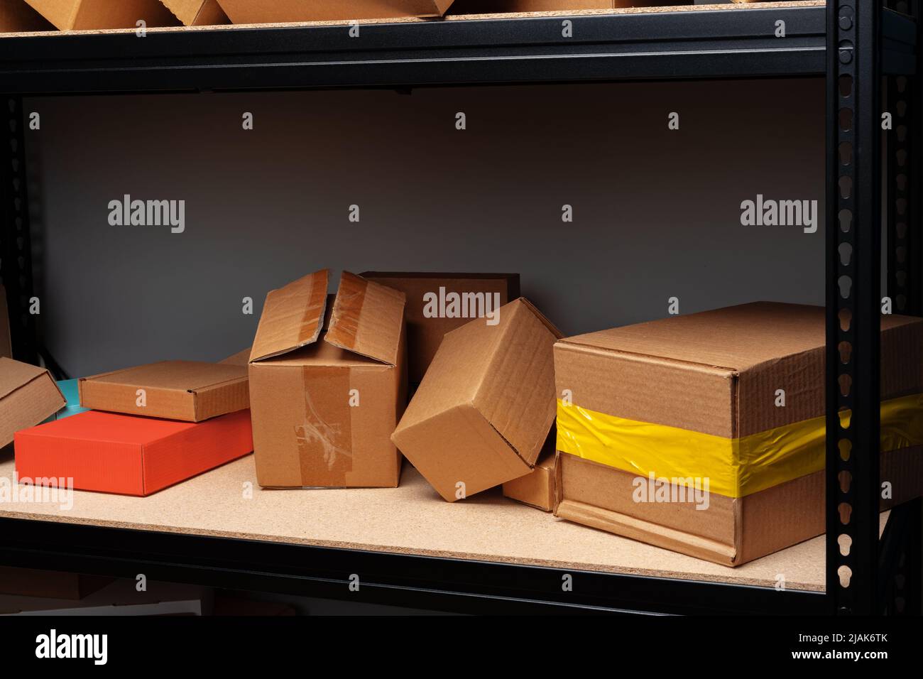Rows of shelves with cardboard boxes in modern warehouse Stock Photo ...