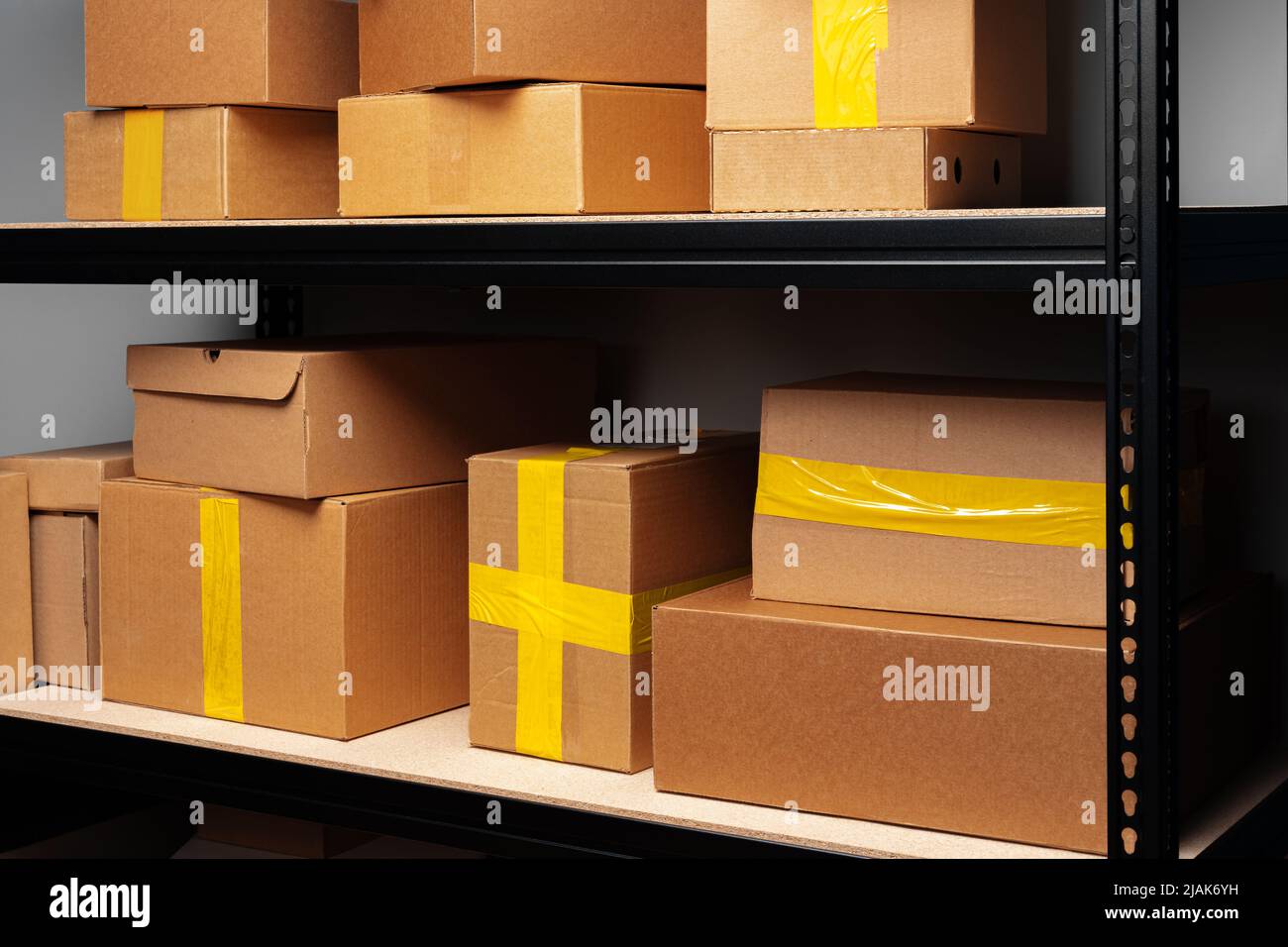 Rows of shelves with cardboard boxes in modern warehouse Stock Photo ...