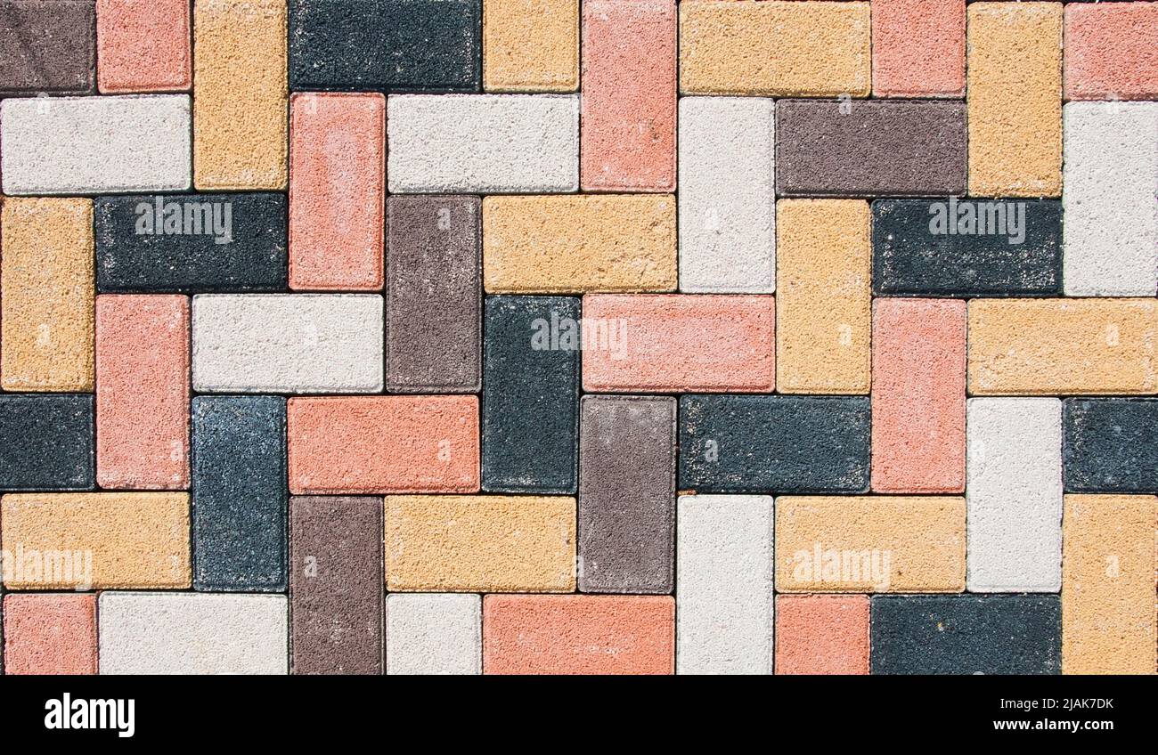 Sidewalk is lined with multi-colored road tiles. View from above Stock ...