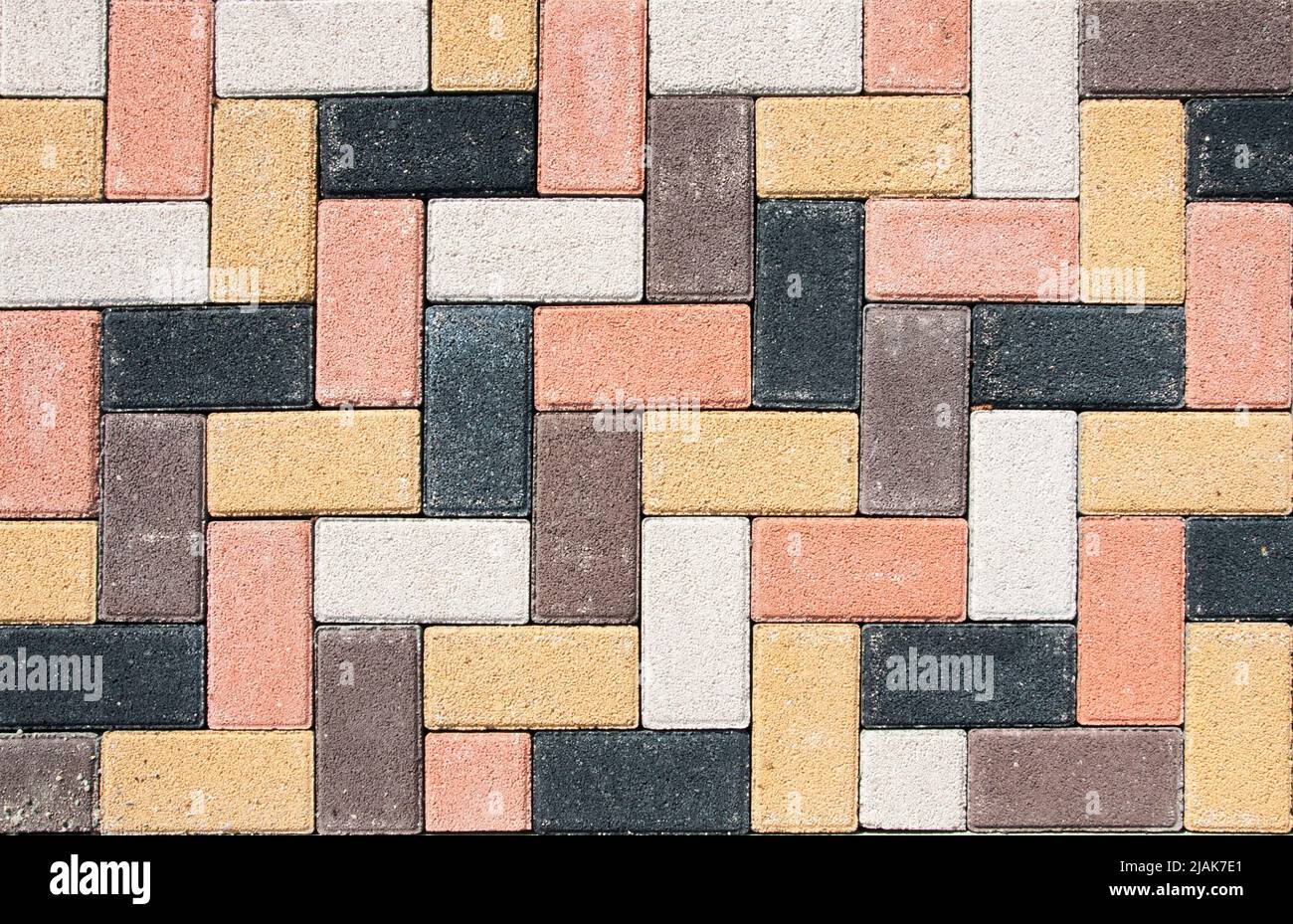 Sidewalk is lined with multi-colored road tiles. View from above Stock ...