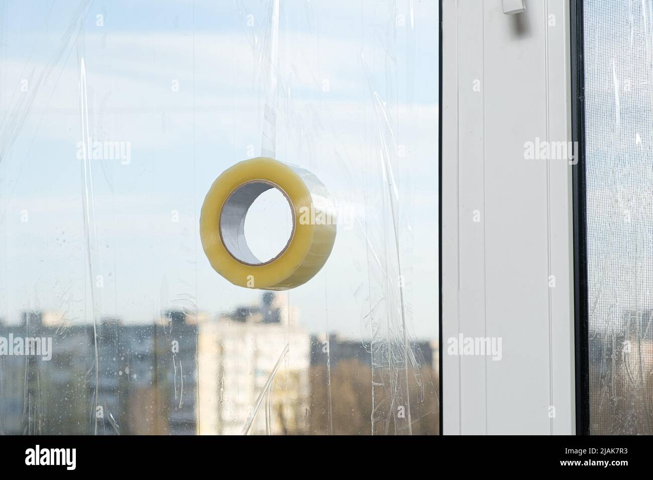 Sealing the windows with adhesive tape during the war in Ukraine to ...