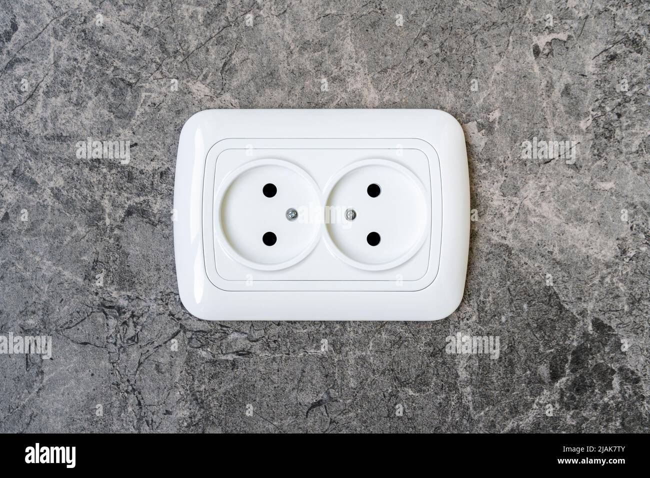 Detail of a double power European electric outlet on tiled wall Stock ...