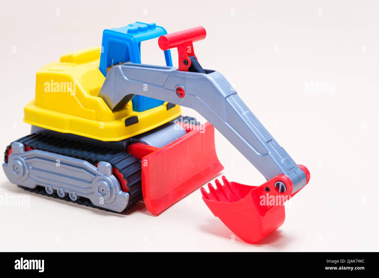 Yellow excavator plastic car on white background. Construction ...