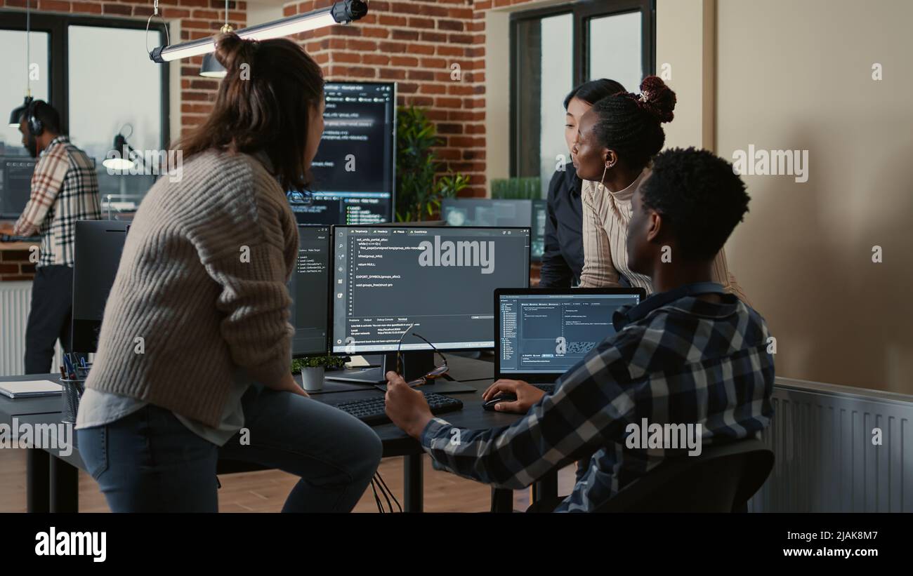 Software developers discussing about cloud programming innovation while ... Software developers discussing about cloud programming innovation while ...