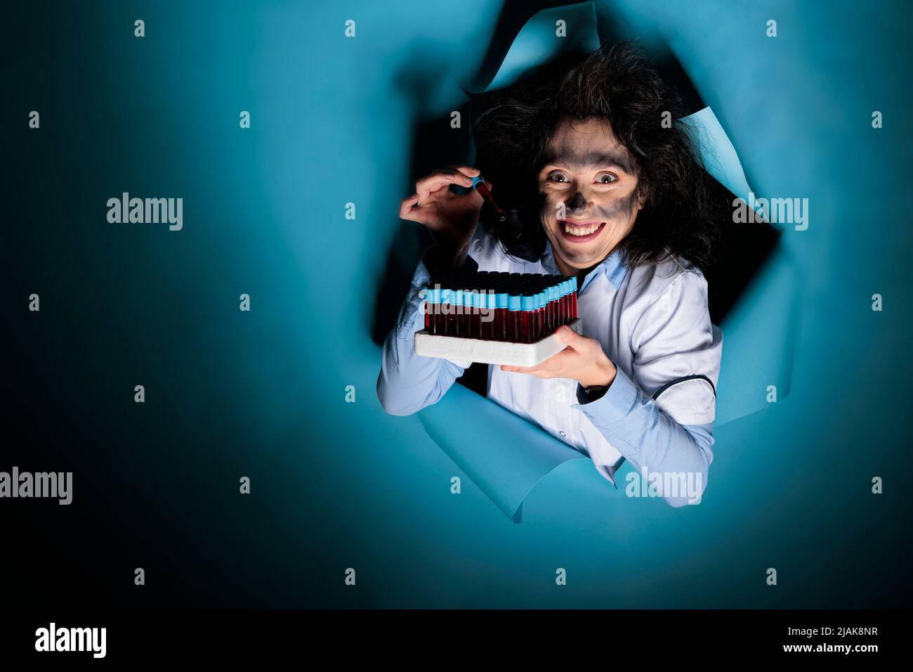 Portrait of foolish maniac chemist with smoky appearance having tray ...