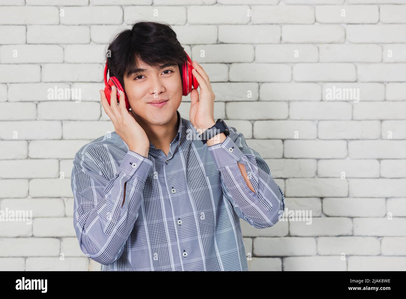 Portrait of Asian handsome young man he smile listening to music in ...