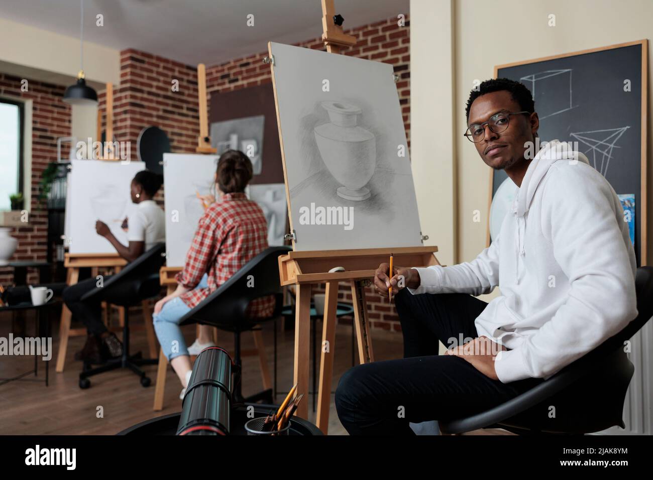 Portrait of painter student attending art class working at creative ...