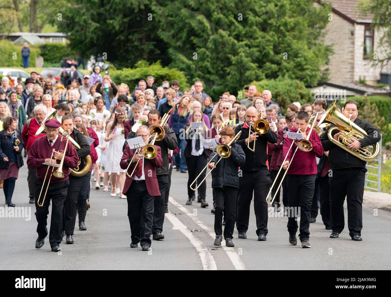 A brass band takes part in the Castleton Garland, an ancient tradition ...