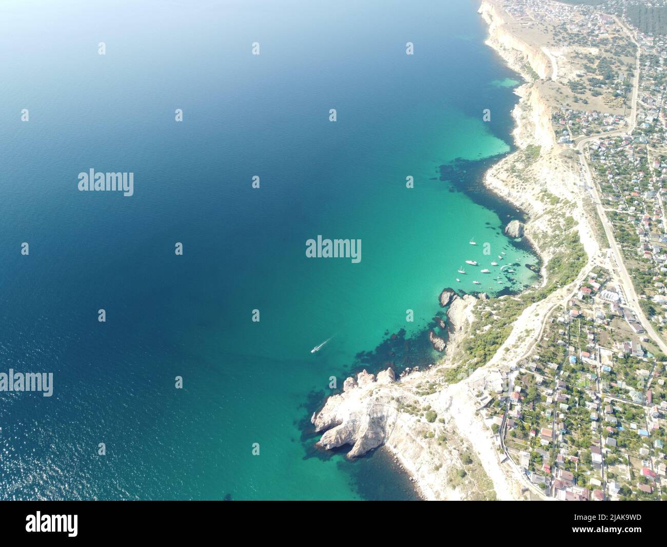 Aerial view from above on calm azure sea and volcanic rocky shores ...