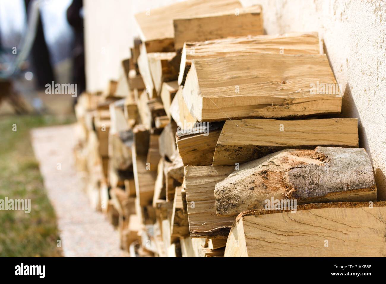 Firewood stacked against a wall Stock Photo - Alamy