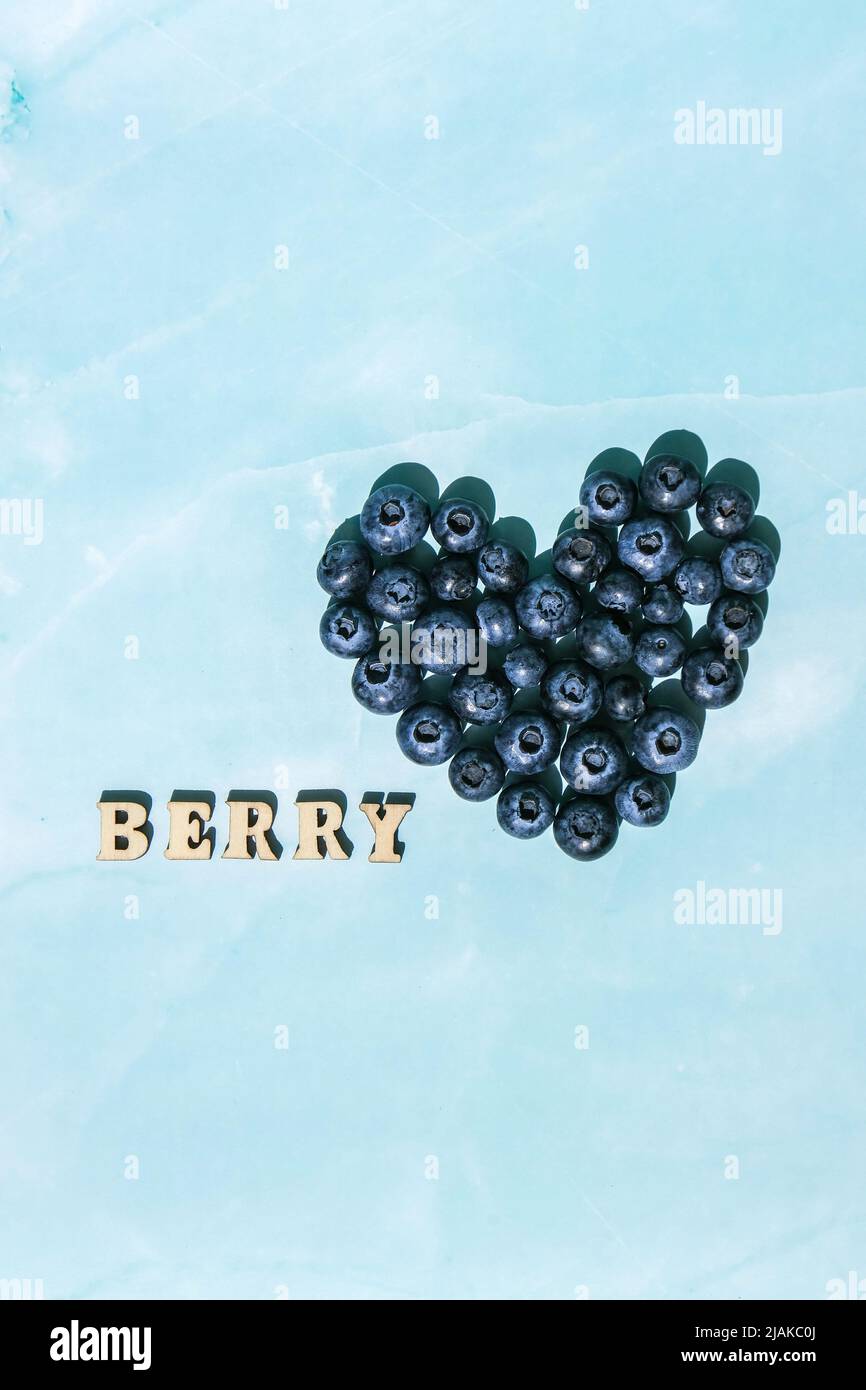 Heart made of Fresh blueberries and BERRY text. Blueberry antioxidant ...