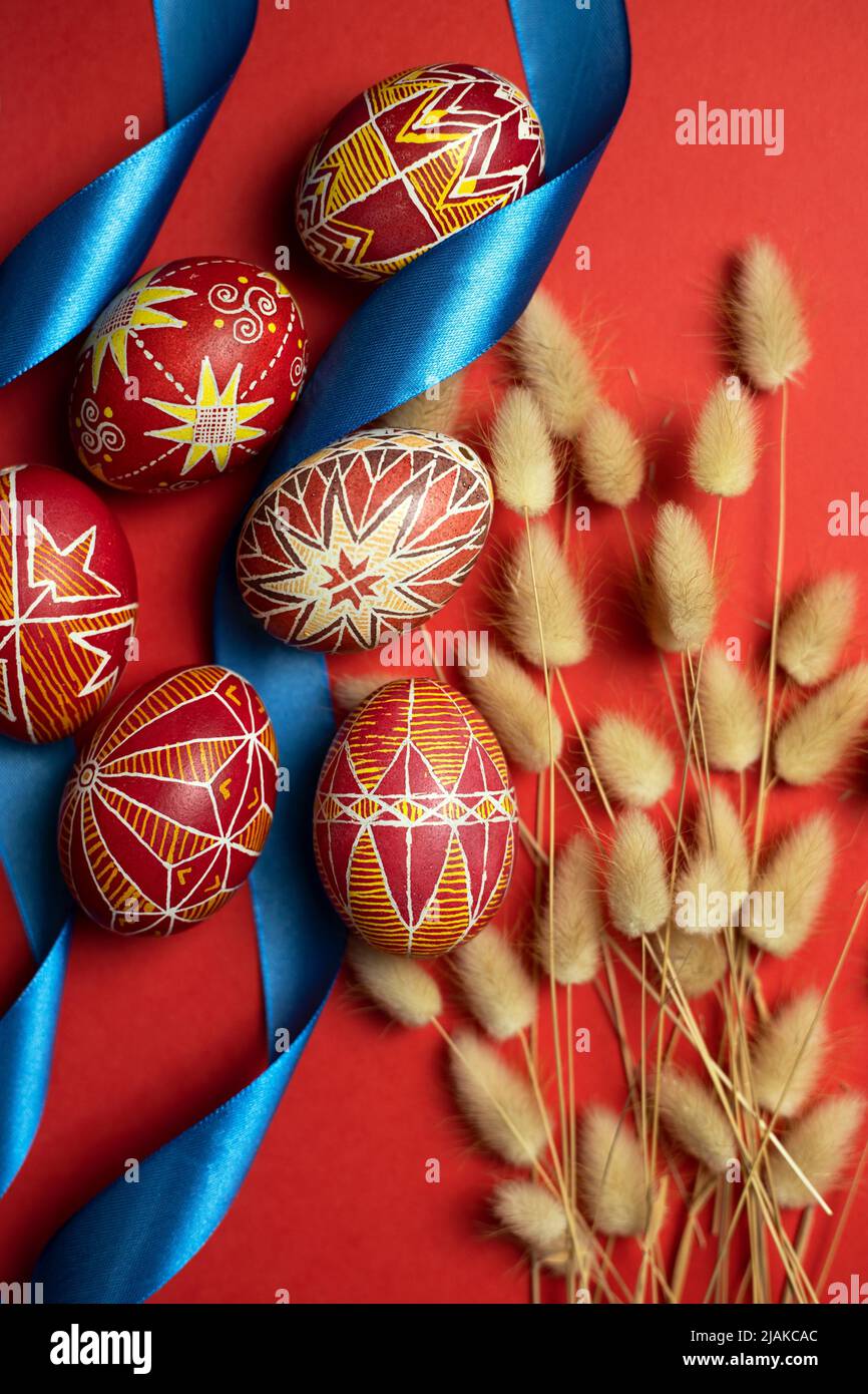 happy easter card. beautiful Easter egg Pysanka handmade on a red ...