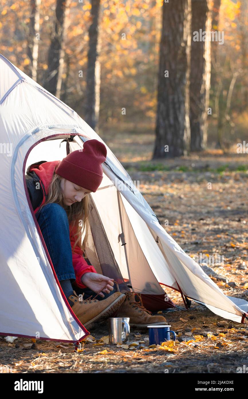 girl hiker in a tent holding a cup and forest in the background Stock ...