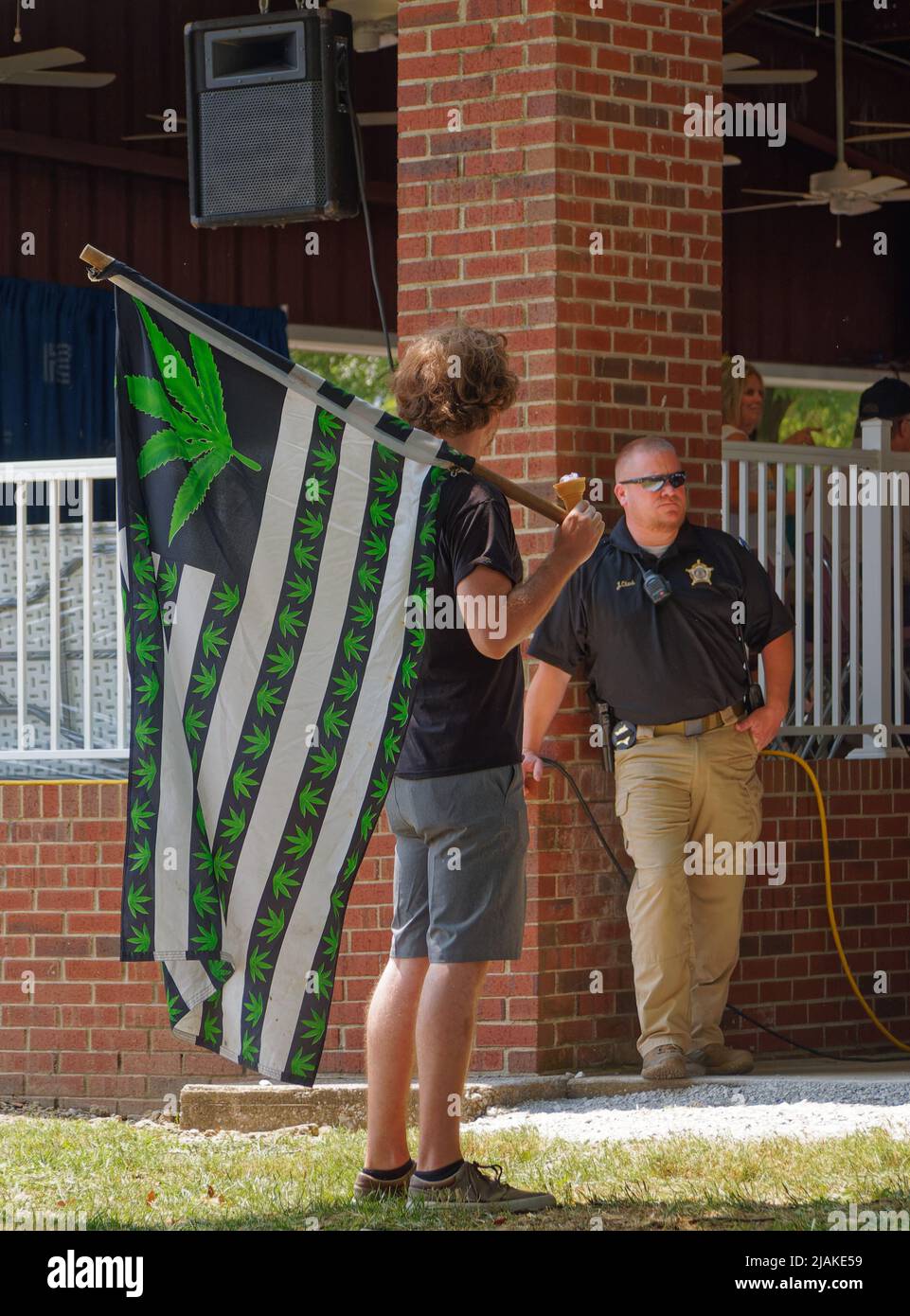 A cannabis legalization advocate carrying an ice cream cone and a flag ...