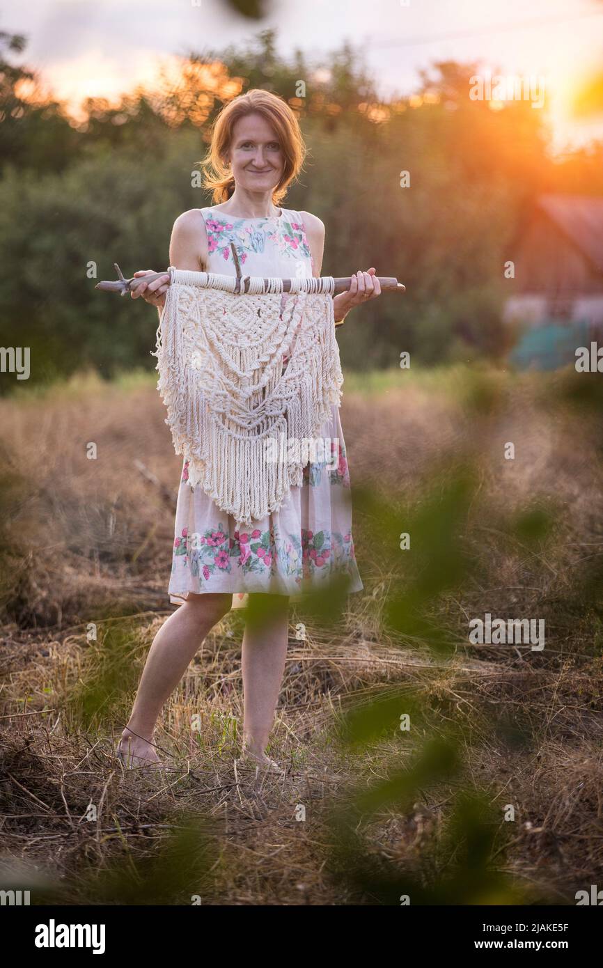 creation of a panel from macrame. girl with macram panel in the sunset ...